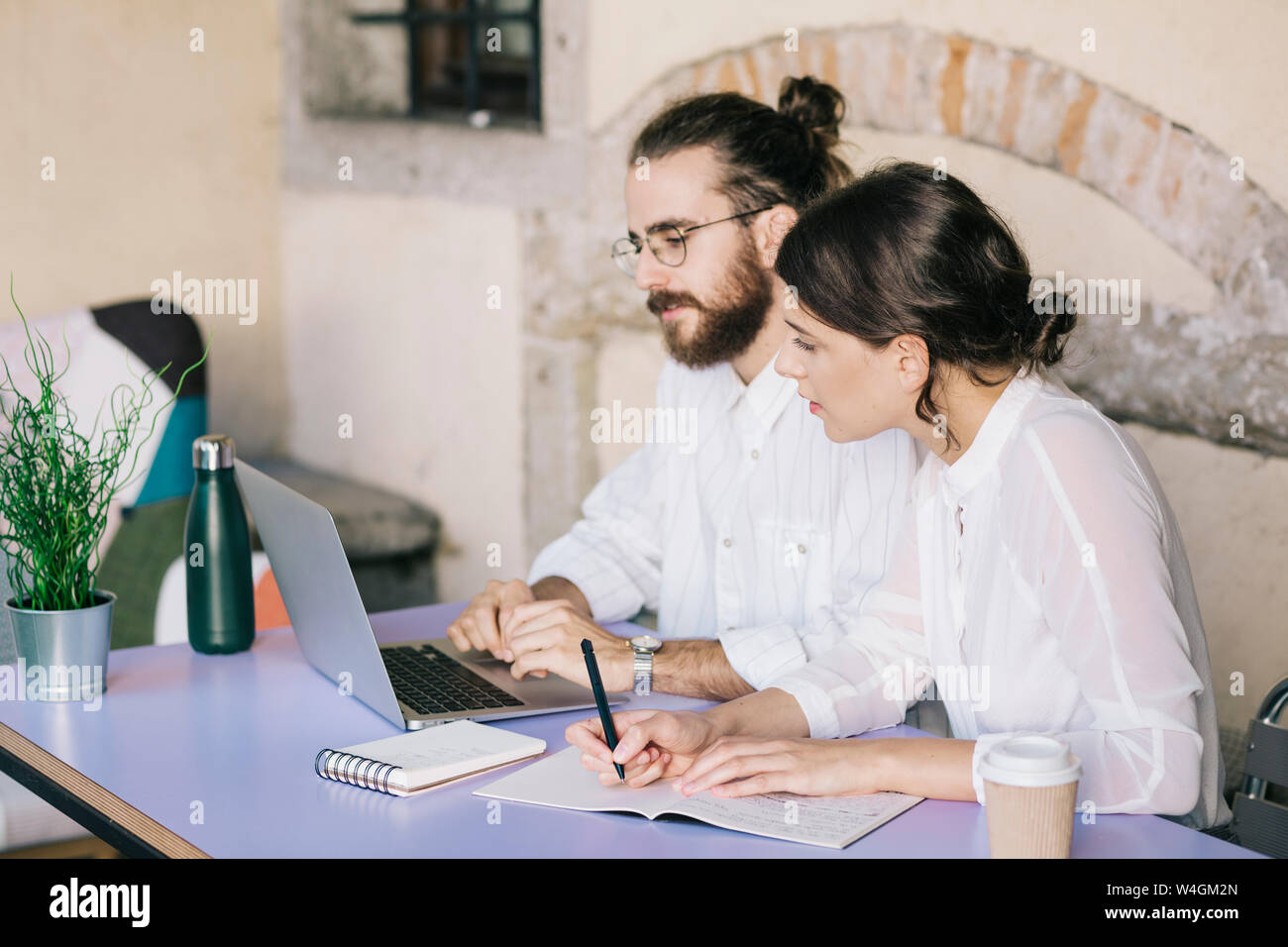 Young business couple working laptop hi-res stock photography and ...