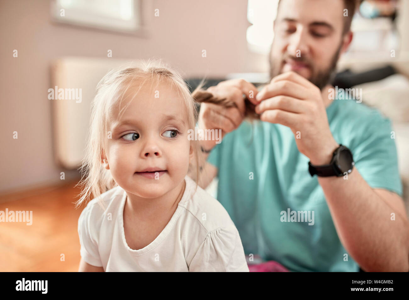 Father braiding hair of his daughter Stock Photo - Alamy