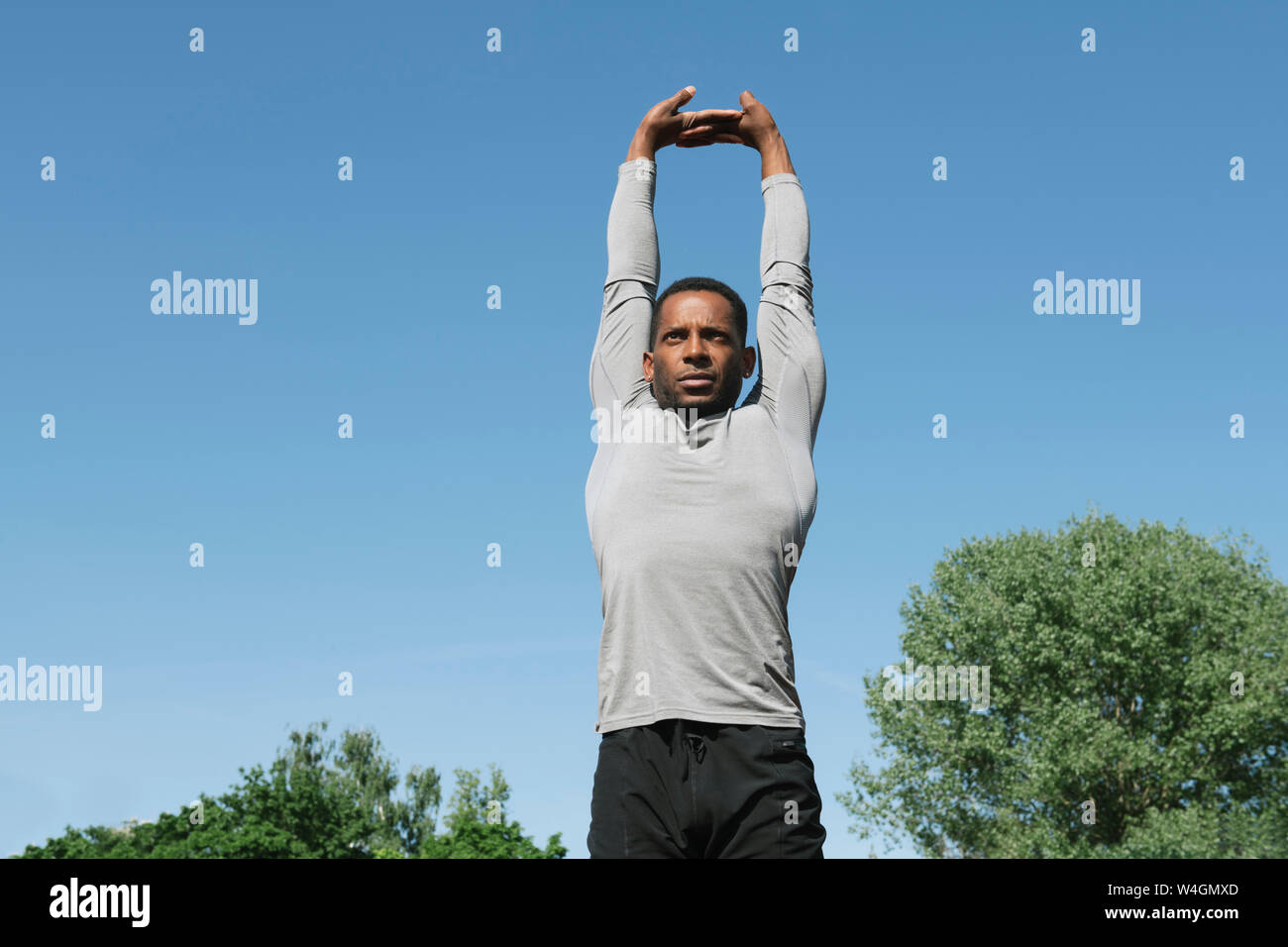 Sportsman stretching his arms Stock Photo - Alamy