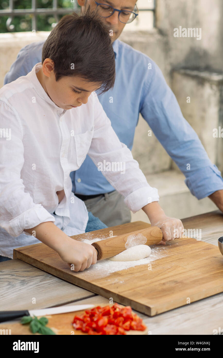 Father and son preparing pizza together Stock Photo - Alamy