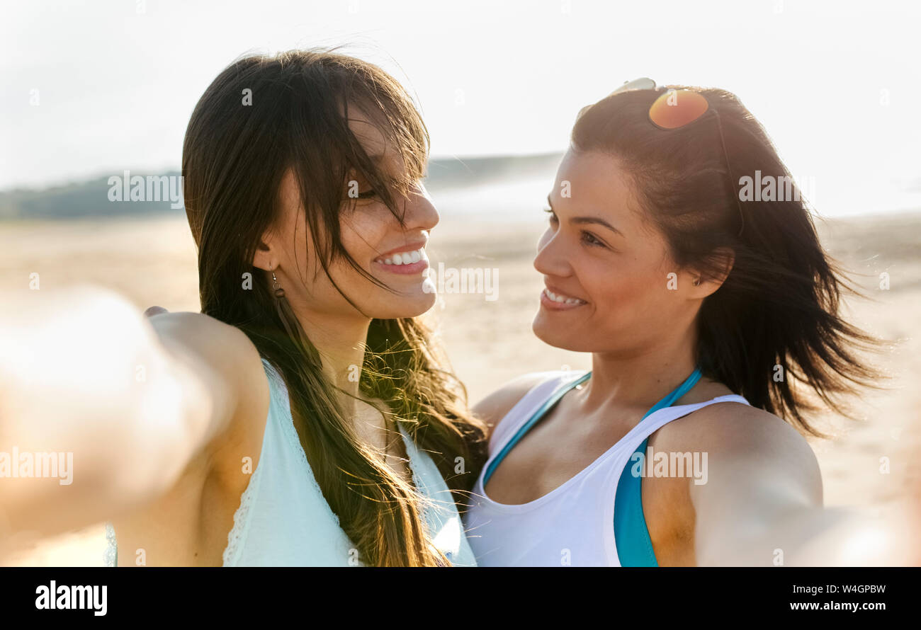 Portrait of two happy female friends on the beach Stock Photo - Alamy