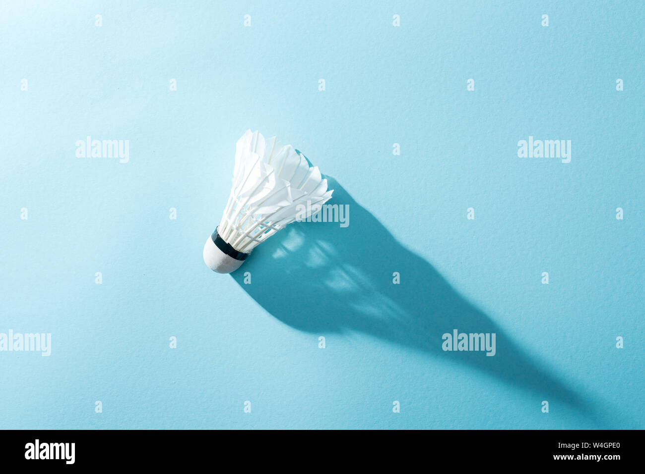 top view of white shuttlecock with feathers on blue Stock Photo - Alamy