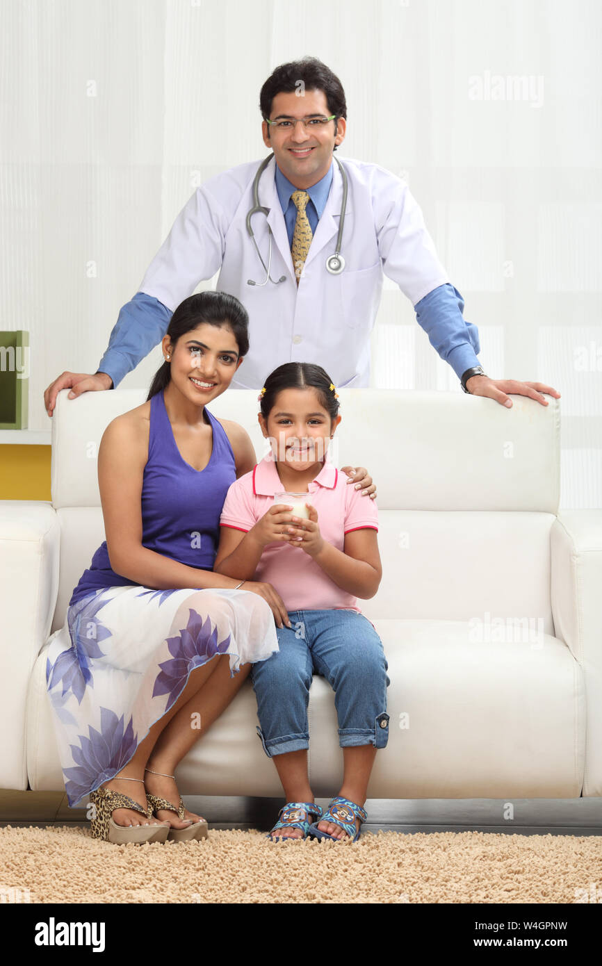 Family with a doctor at home Stock Photo - Alamy