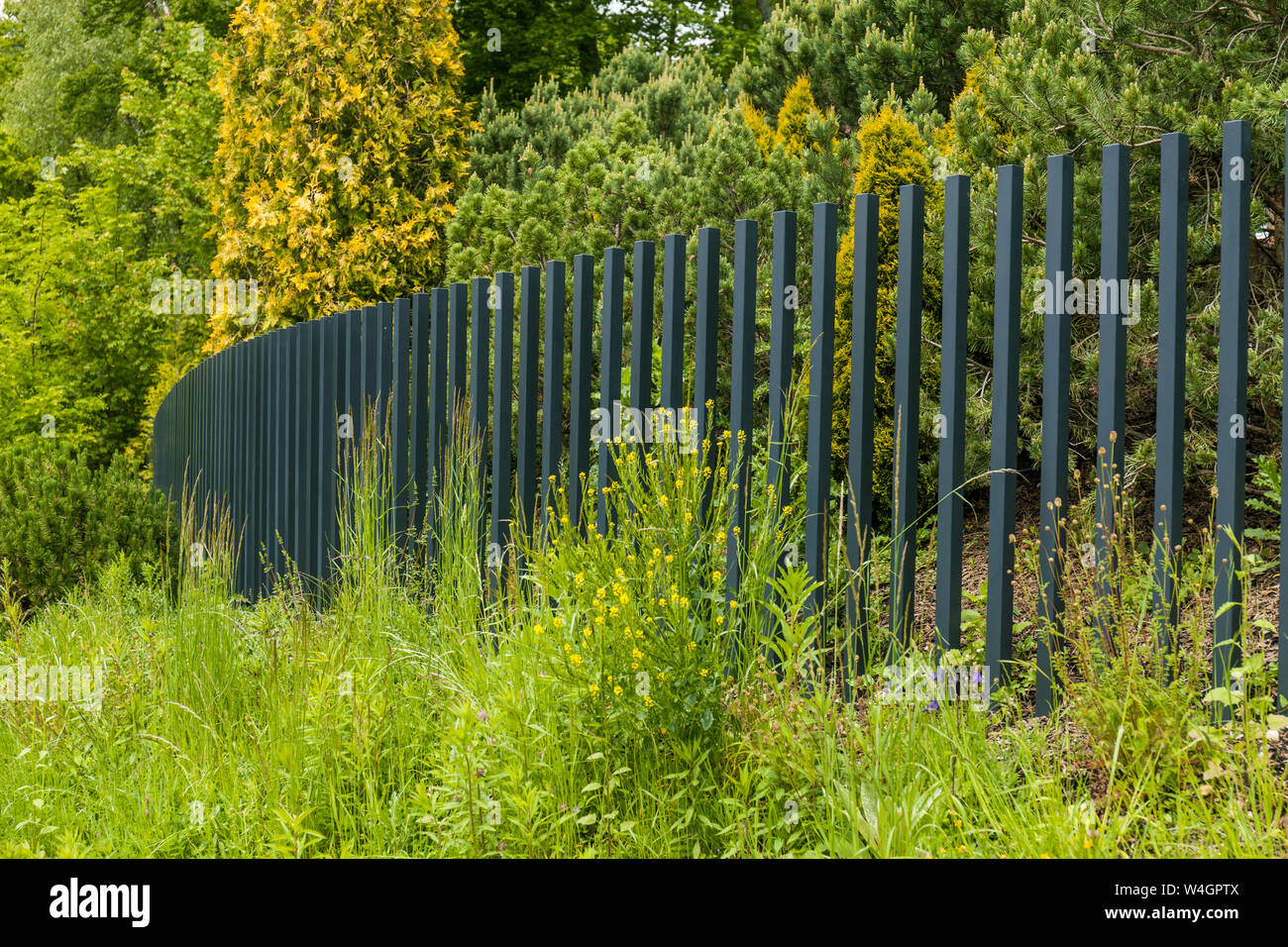 Metal fence in rural landscape Stock Photo - Alamy