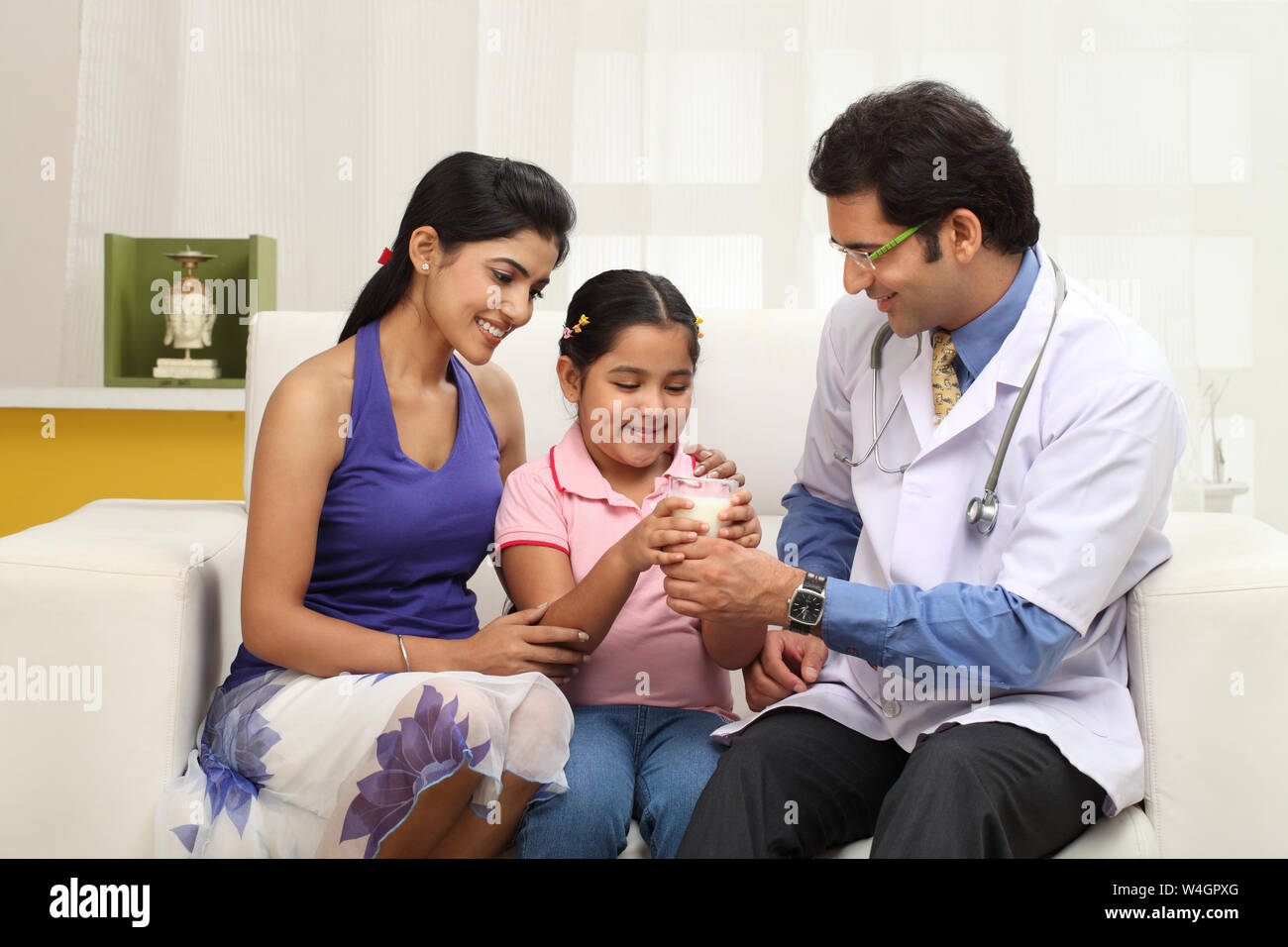 Family with a doctor at home Stock Photo - Alamy