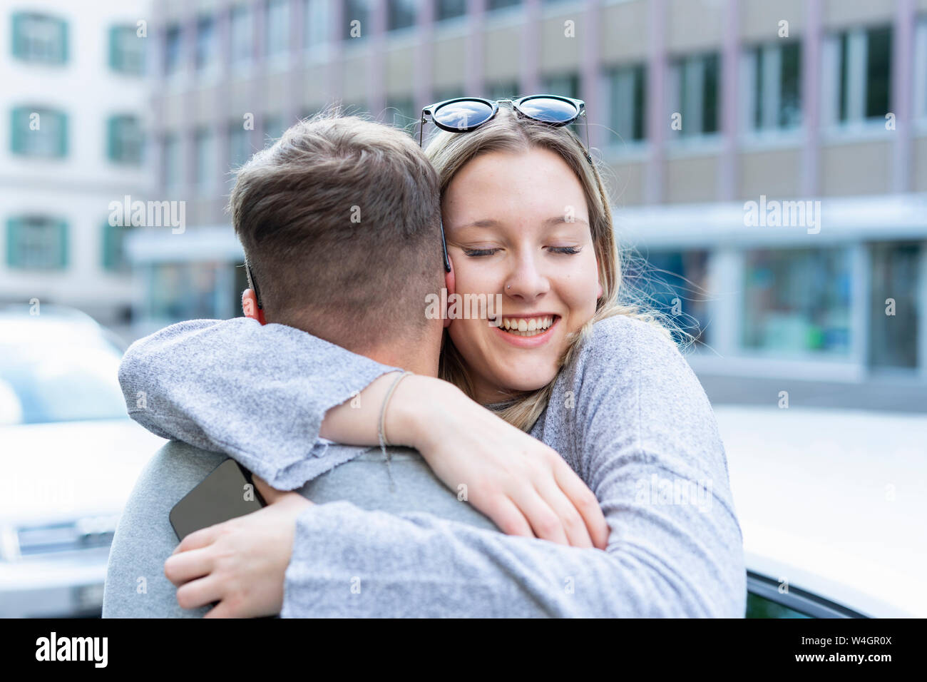 Portrait of happy young woman hugging her boyfriend Stock Photo - Alamy
