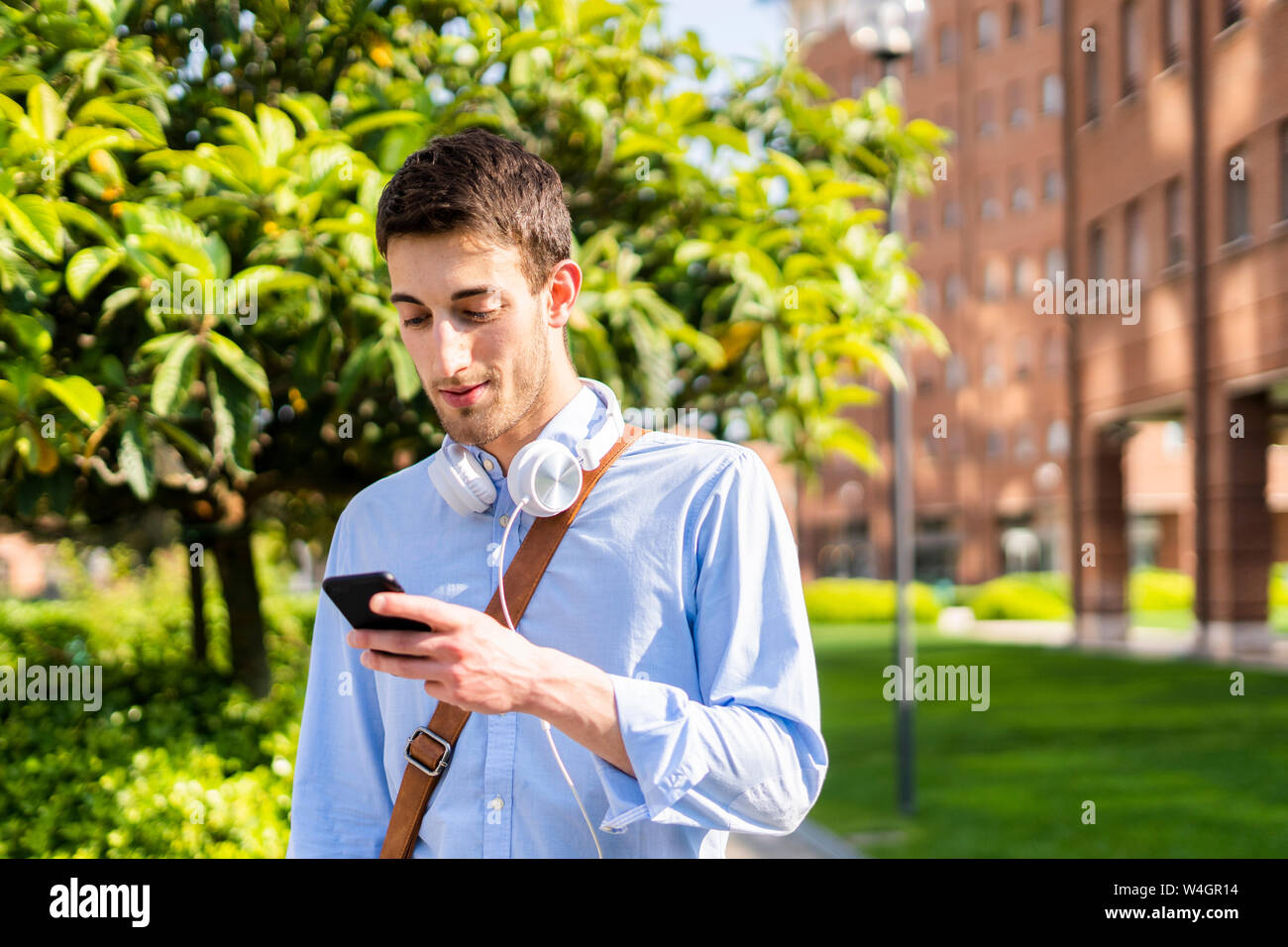 Young man holding smartphone using hi-res stock photography and images ...