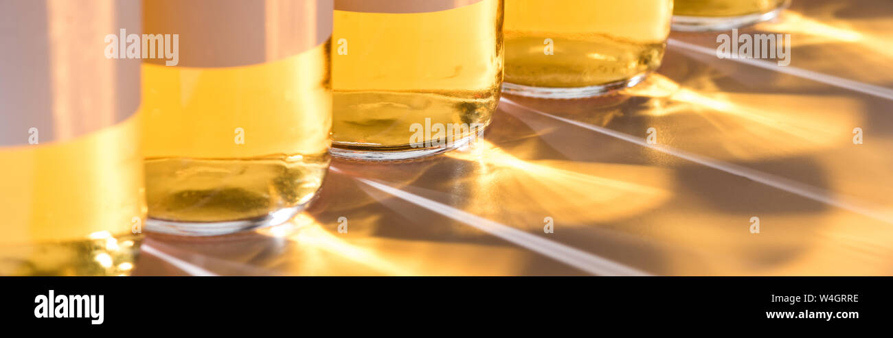 close up view of beer bottles with light and shadow, panoramic shot ...