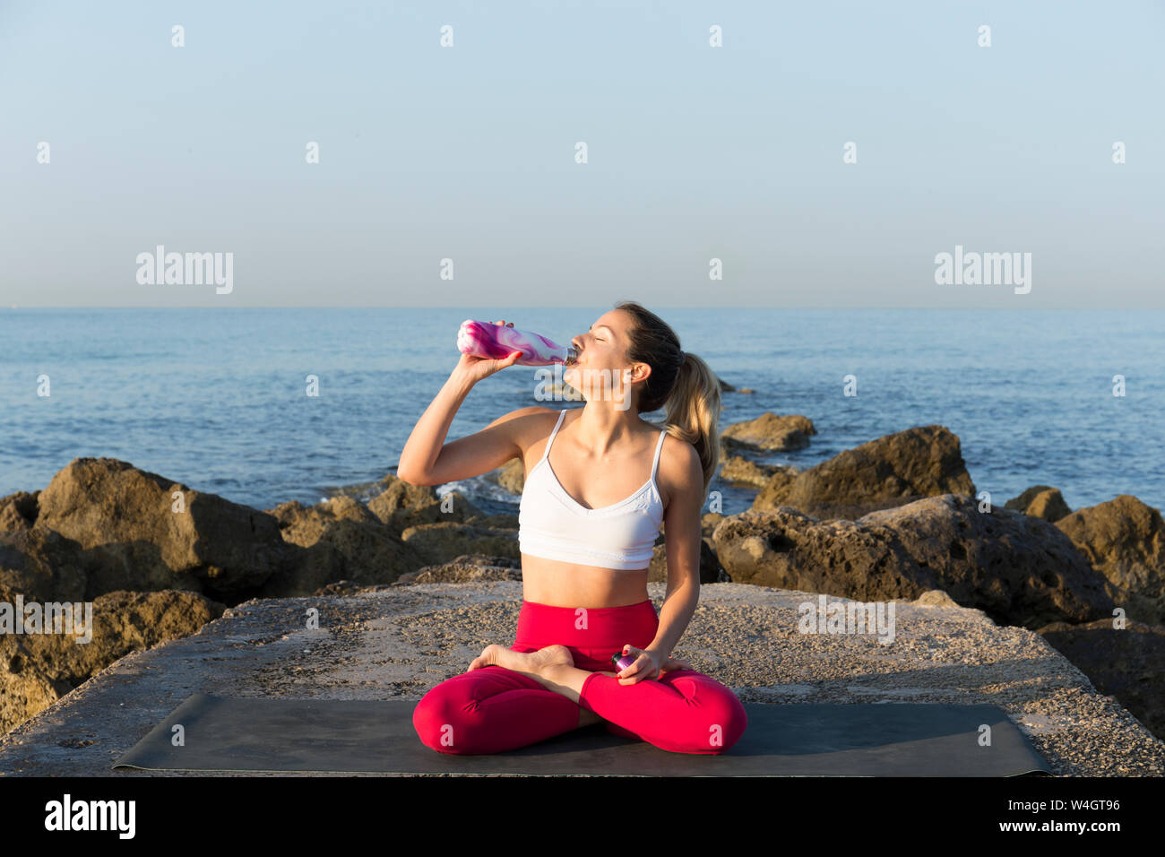 Woman beach drink water hi-res stock photography and images - Alamy