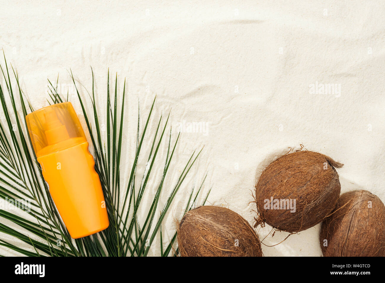top view of palm leaves, coconuts and sunscreen on sand Stock Photo - Alamy