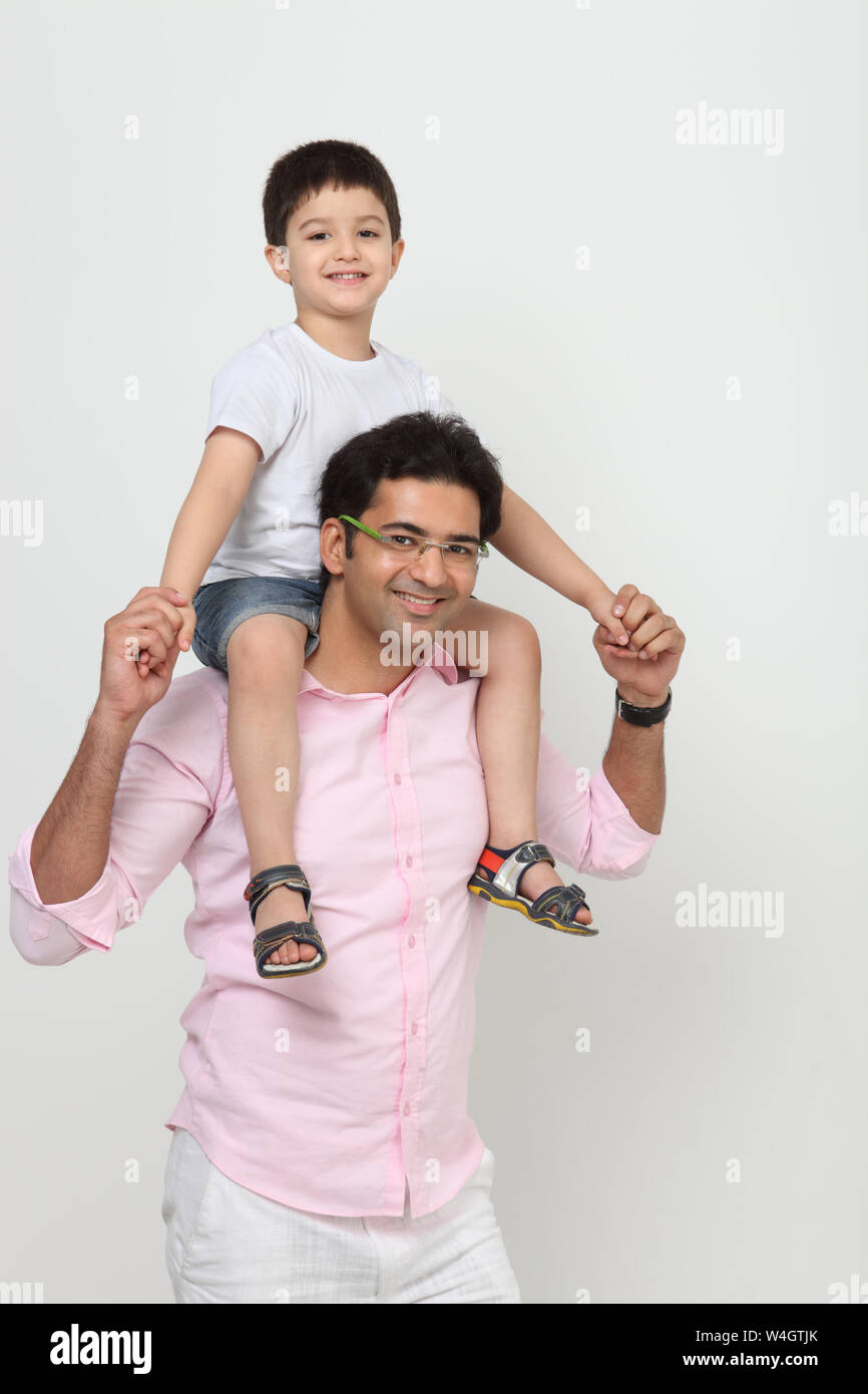 Man carrying his son on shoulders Stock Photo - Alamy
