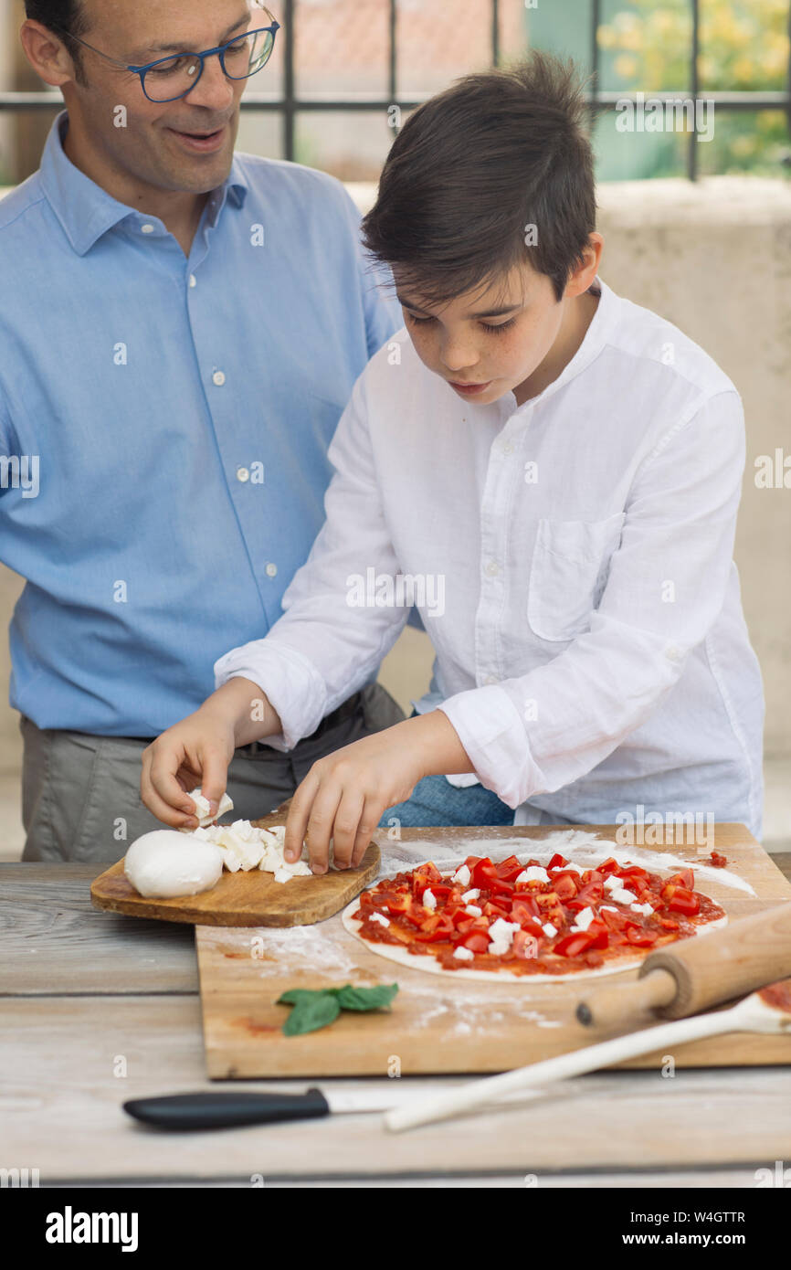 Father and son preparing pizza together Stock Photo - Alamy