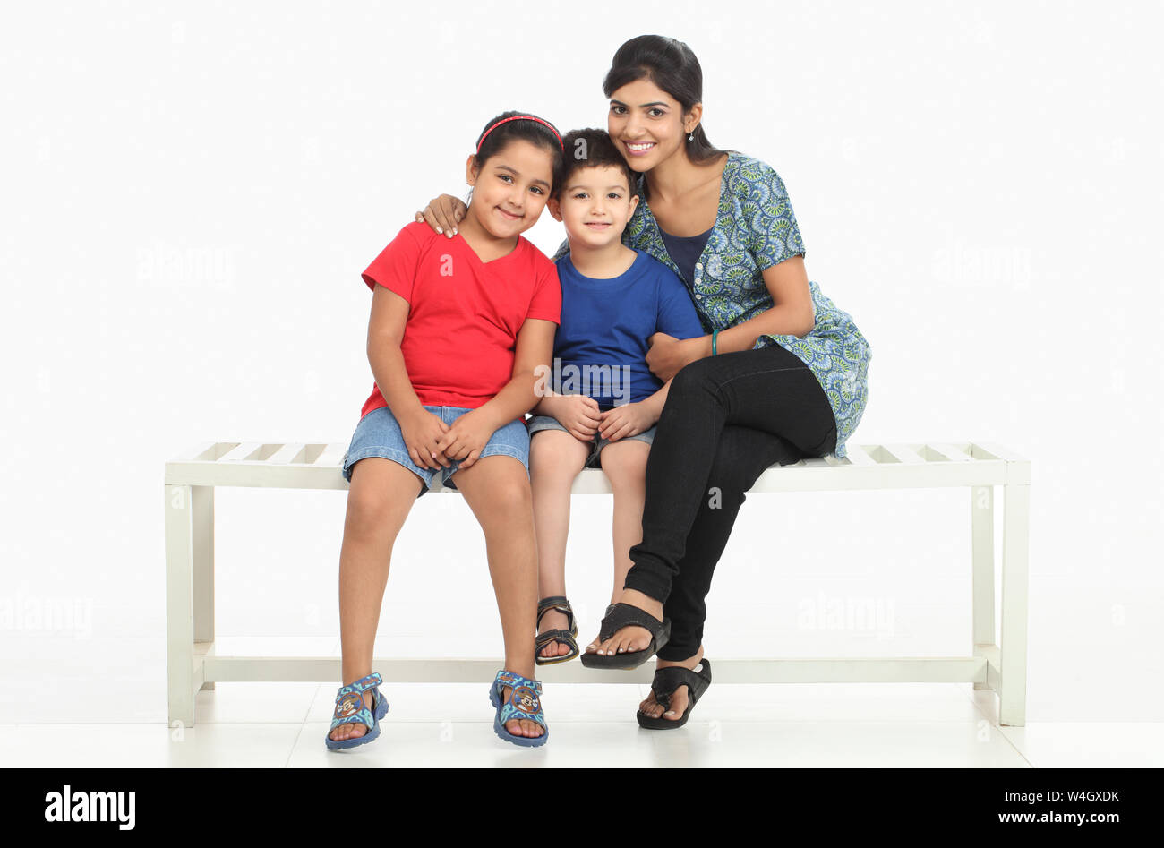 Woman sitting on a bench with their children Stock Photo - Alamy