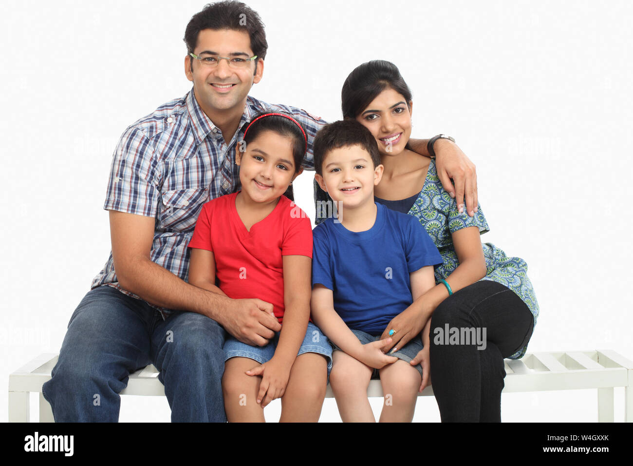Family sitting on a bench Stock Photo - Alamy
