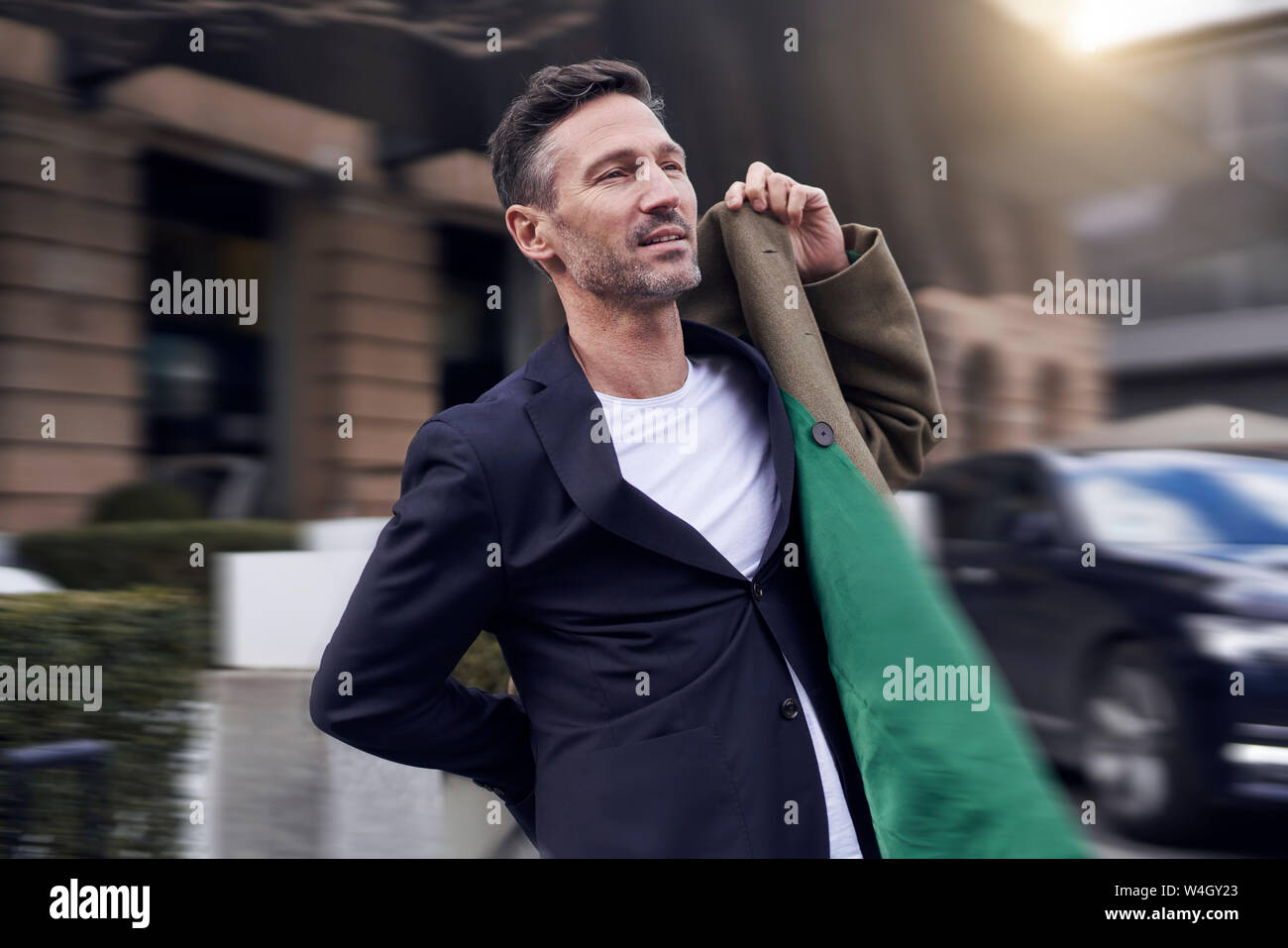 Mature man dressing his coat Stock Photo - Alamy