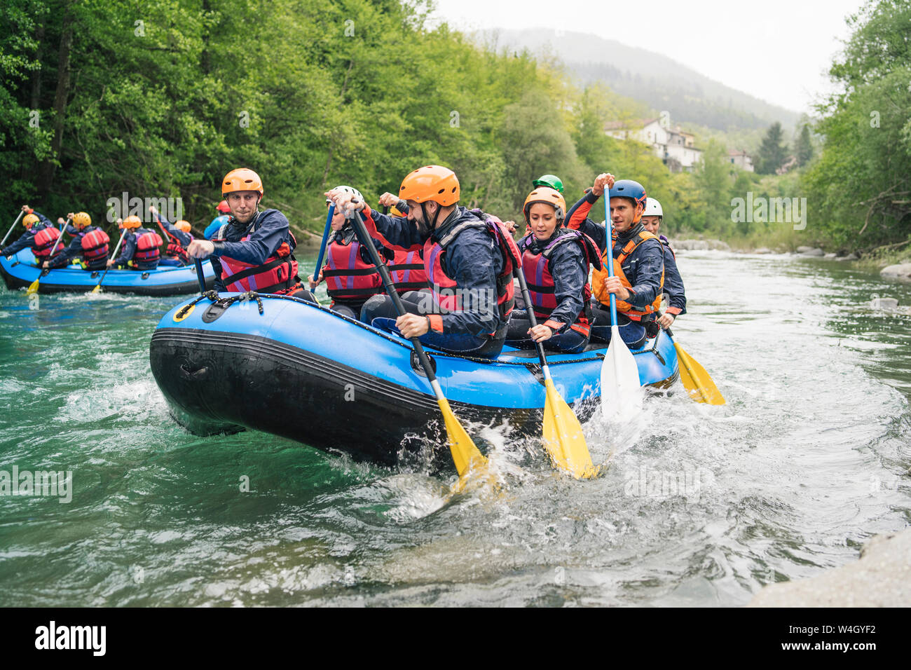 Group of people rafting in rubber dinghy on a river Stock Photo - Alamy