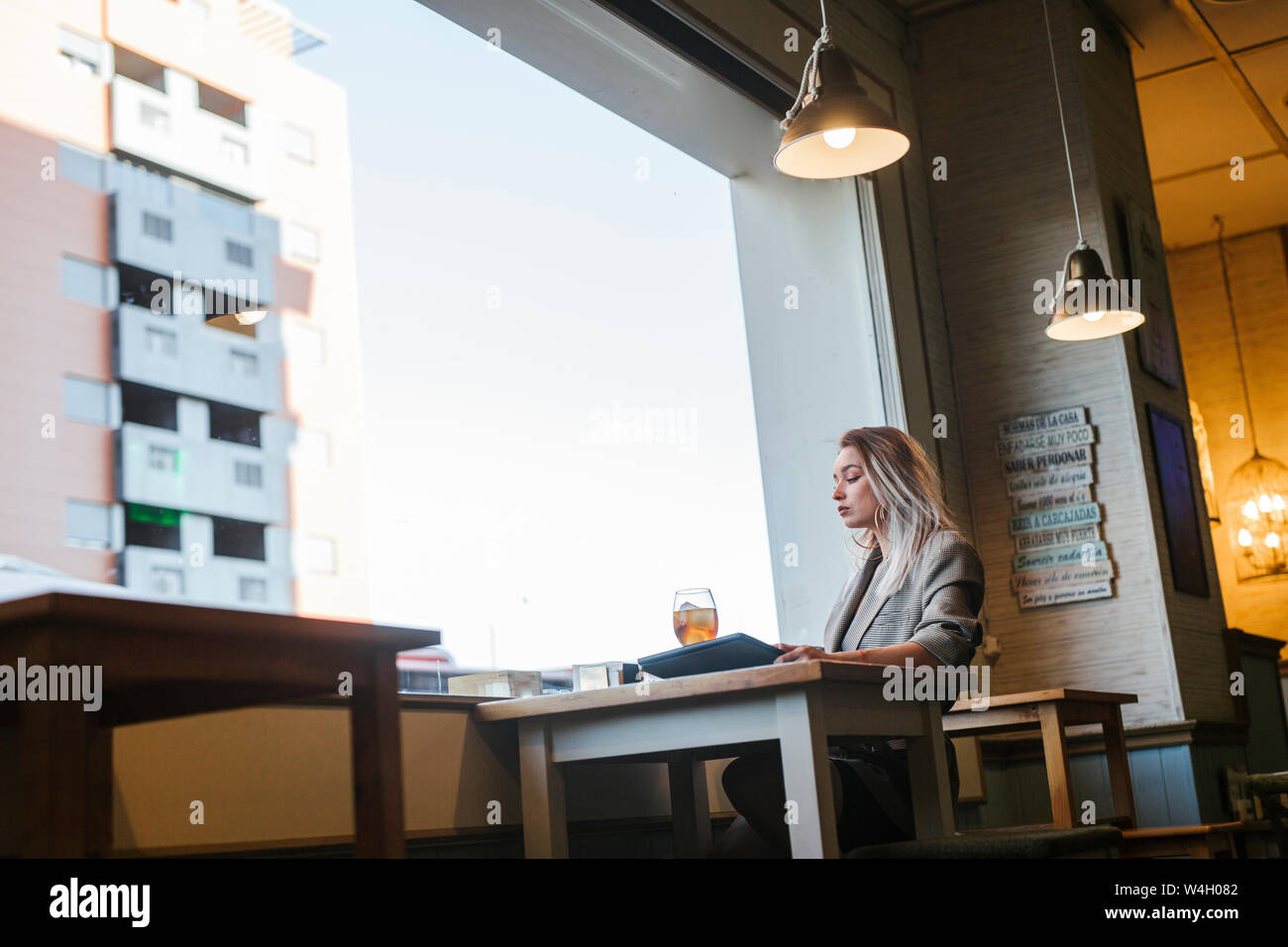 Young woman high rise building sitting window hi-res stock photography ...