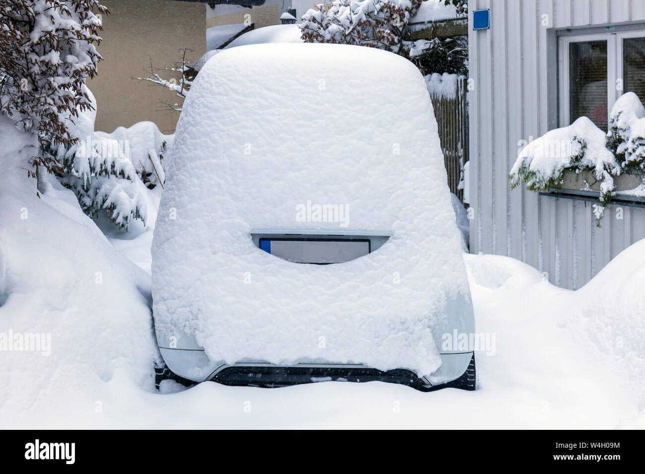 Snow-covered compact car, Germany Stock Photo - Alamy