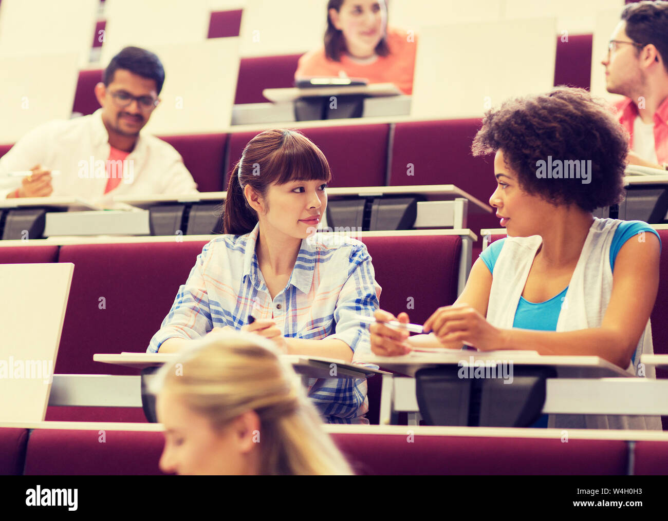 group of students talking in lecture hall Stock Photo - Alamy