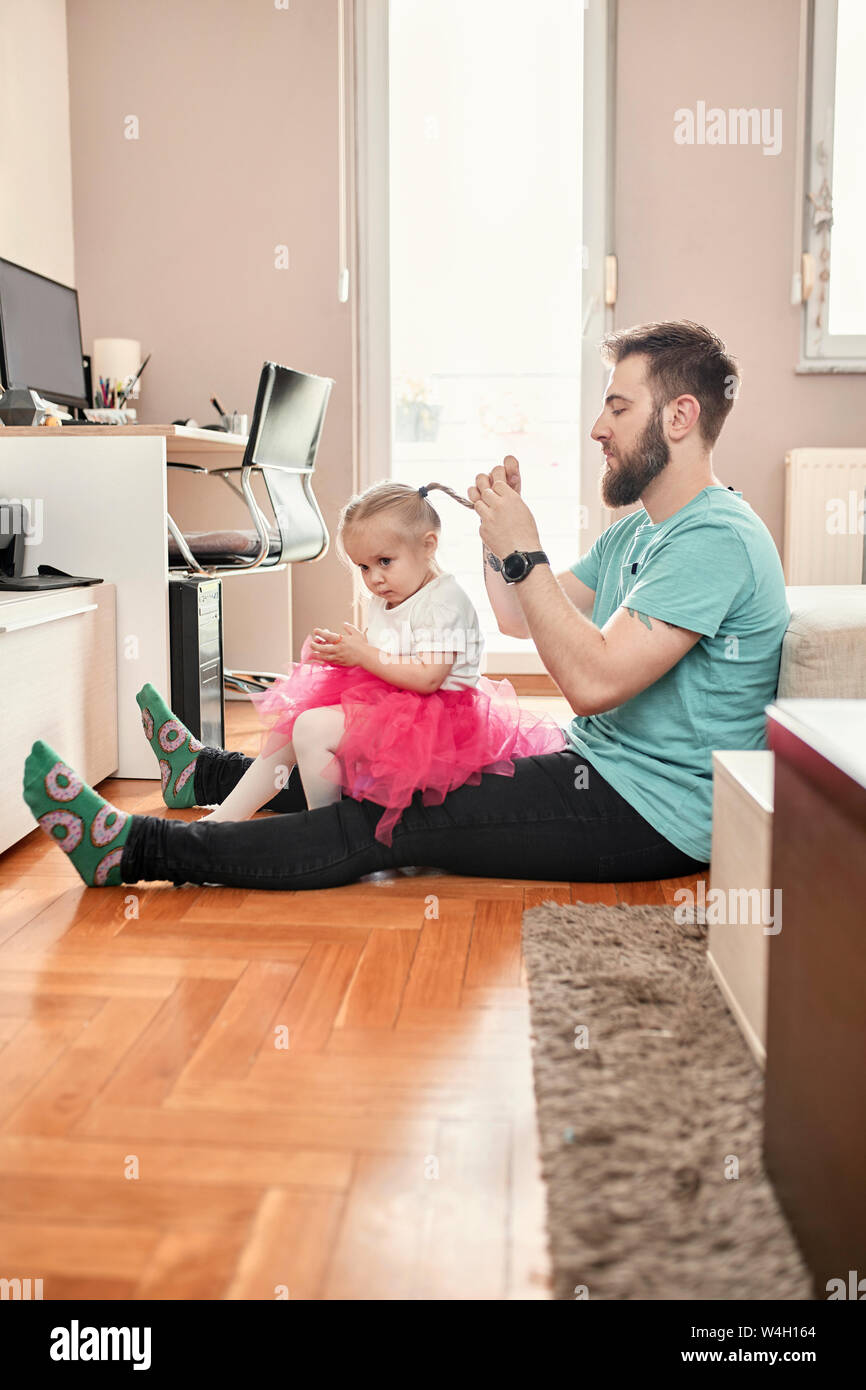 Father braiding hair of his daughter Stock Photo - Alamy