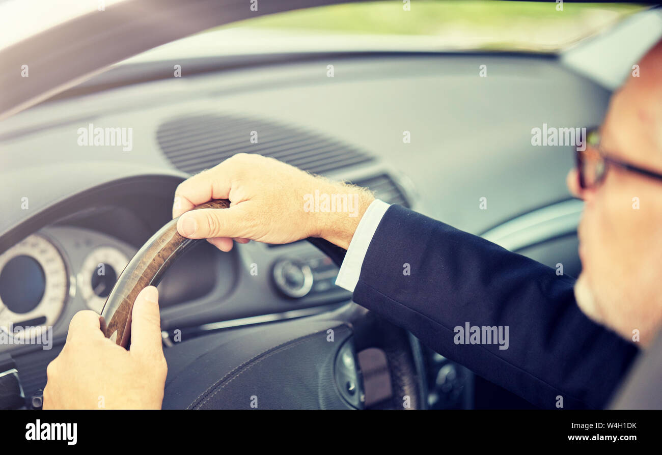 senior businessman hands driving car Stock Photo - Alamy