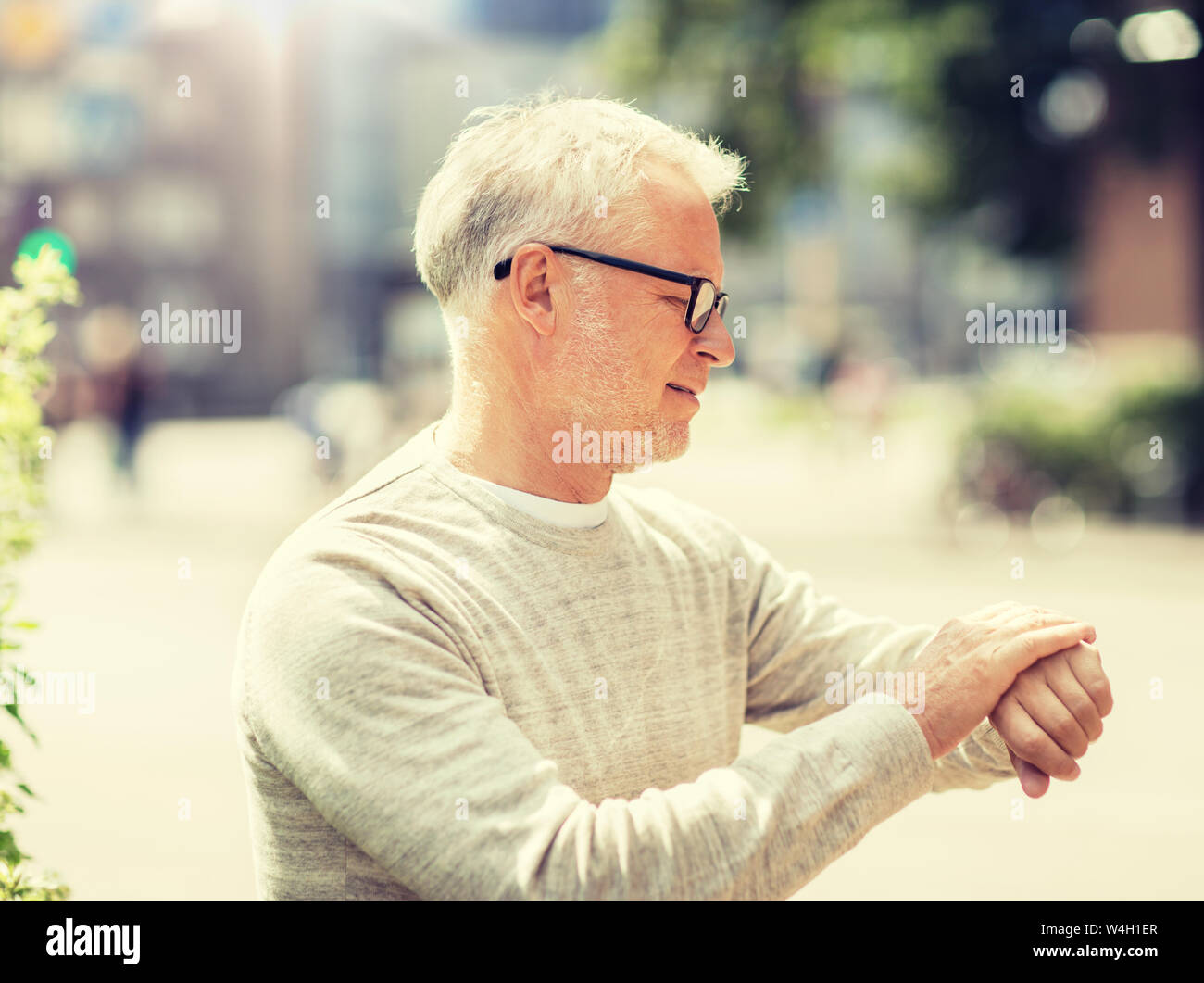 senior man checking time on his wristwatch Stock Photo - Alamy