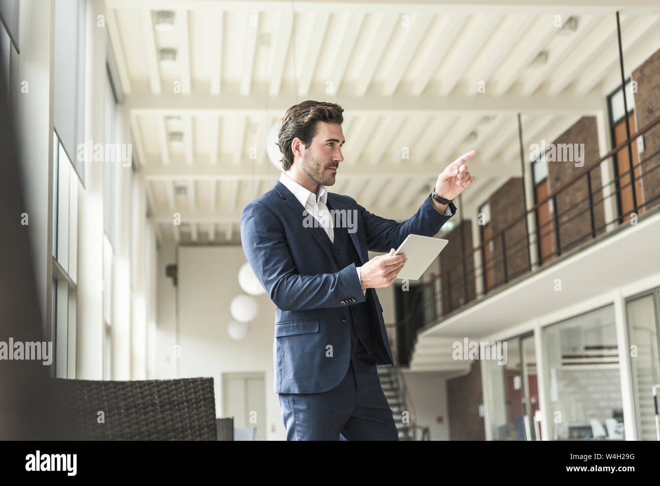 Businessman pointing modern building hi-res stock photography and ...
