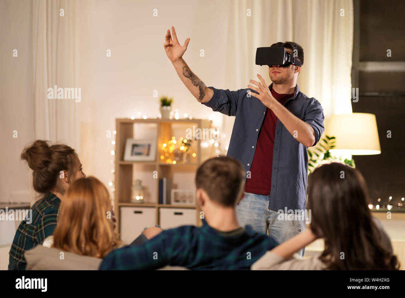 man in vr glasses at home with friends Stock Photo - Alamy