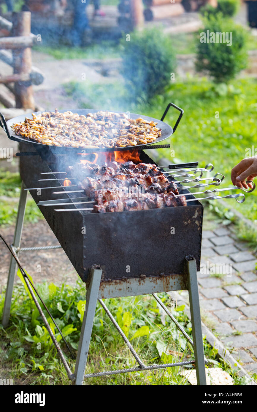 cooking meat at bbq fire close up Stock Photo - Alamy