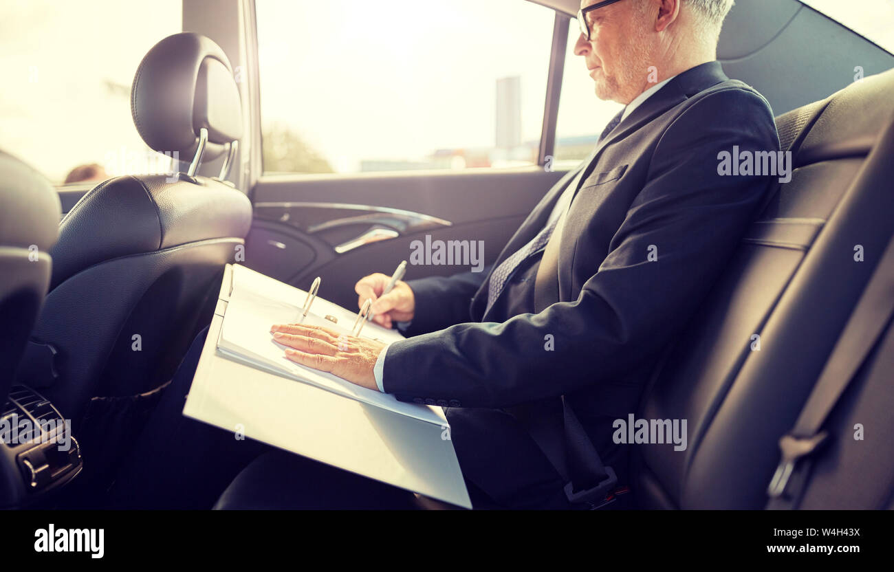 Elderly man signing papers hi-res stock photography and images - Alamy