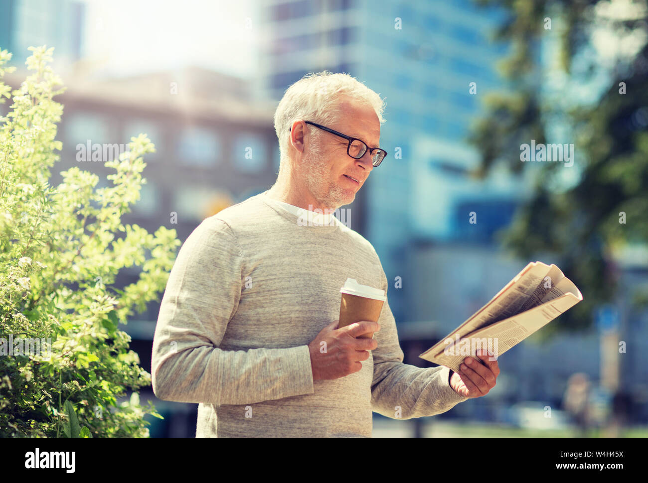 senior man reading newspaper and drinking coffee Stock Photo - Alamy