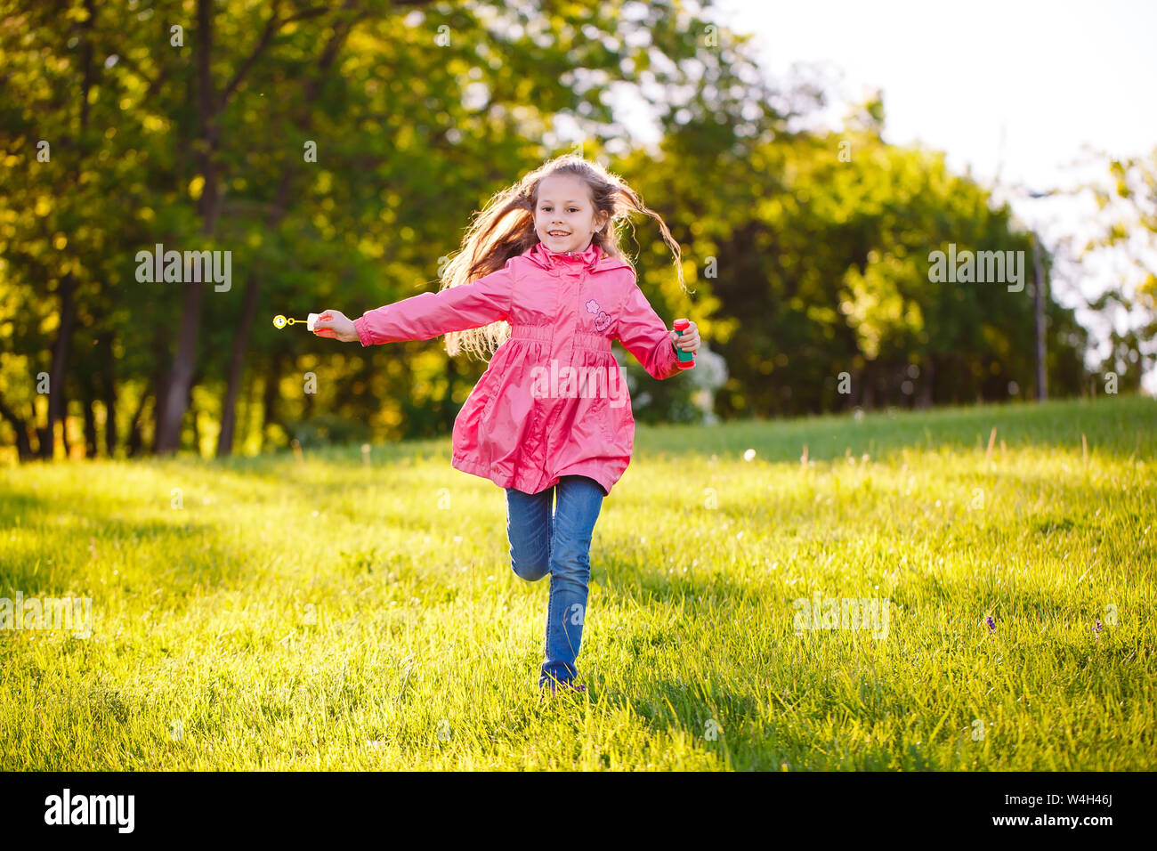 Girl blowing bubbles running hi-res stock photography and images - Alamy