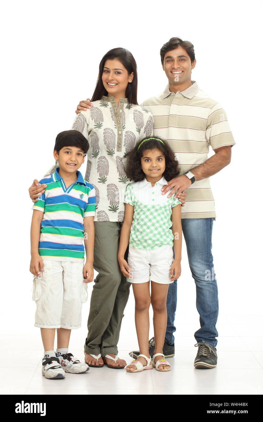 Family standing together and smiling Stock Photo - Alamy