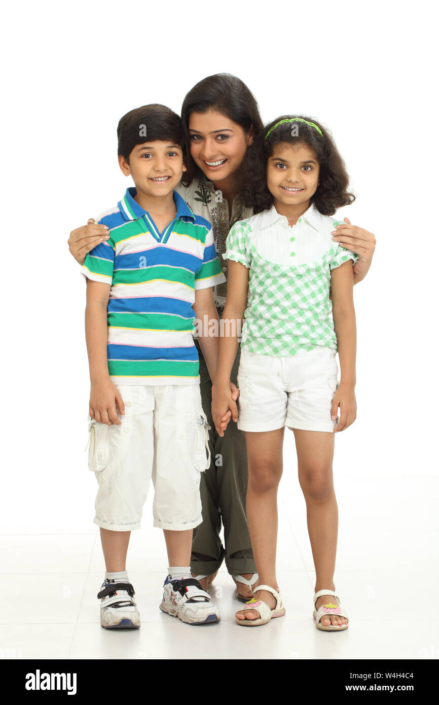 Woman with two children standing together and smiling Stock Photo - Alamy