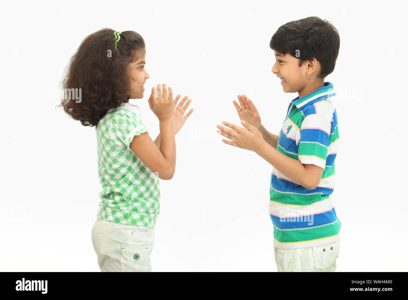 Two children playing a clapping game Stock Photo - Alamy