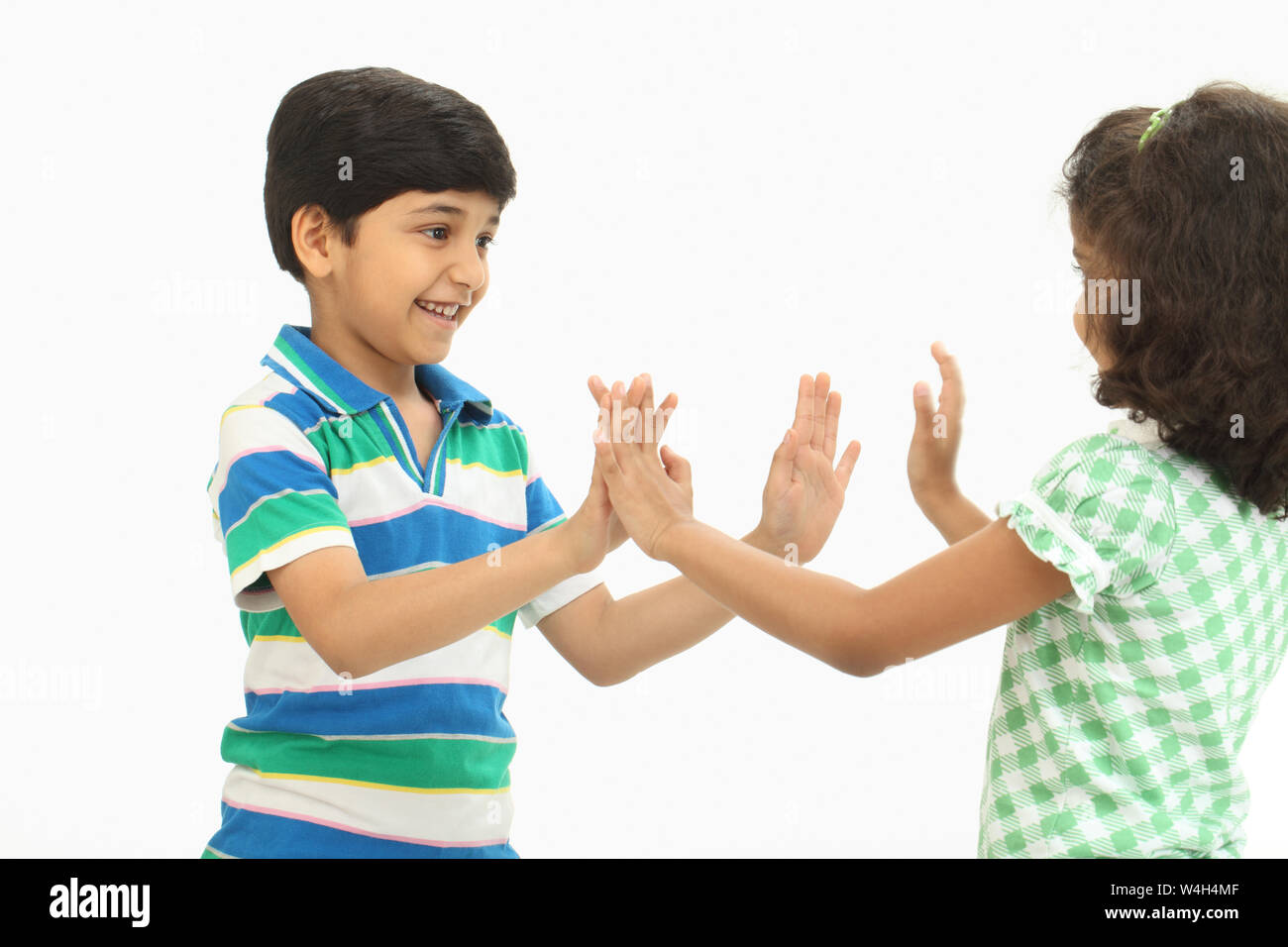 Two children playing a clapping game Stock Photo Alamy