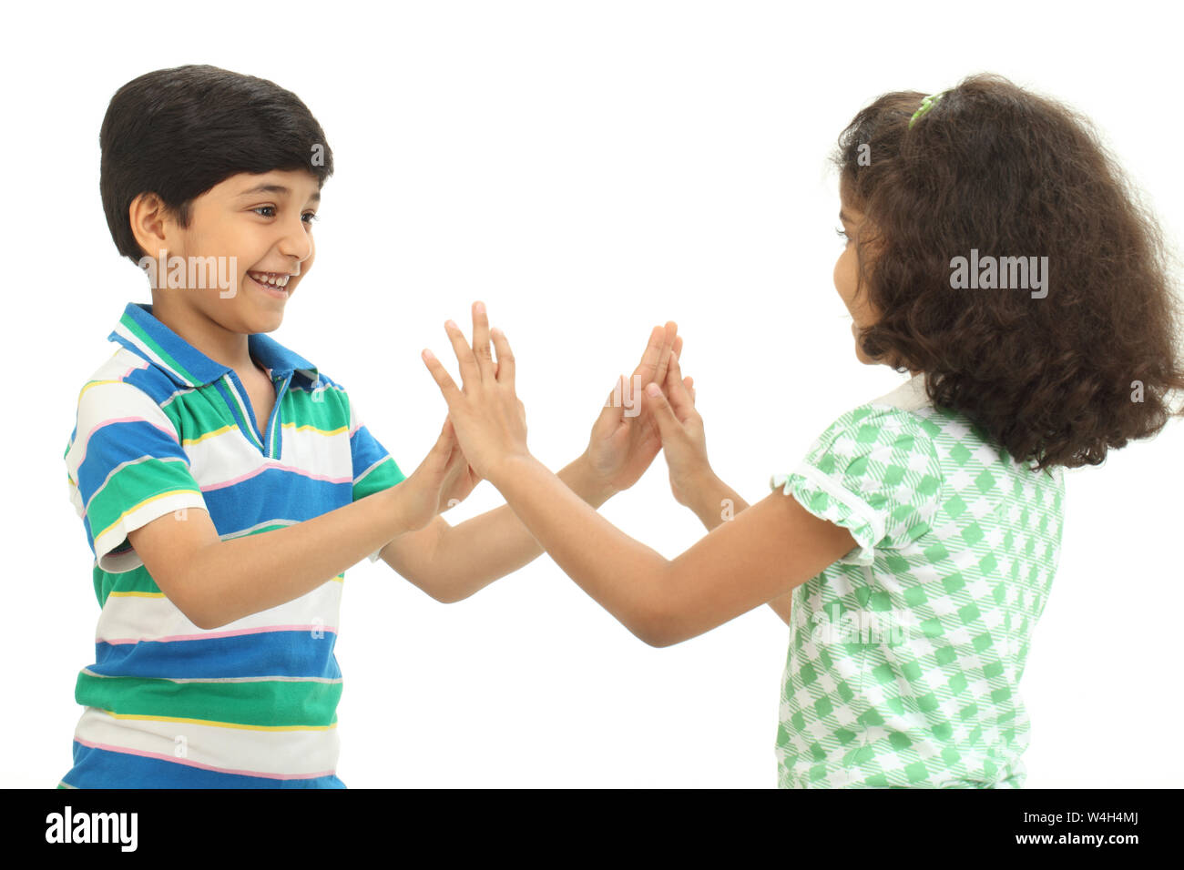 Two children playing a clapping game Stock Photo - Alamy