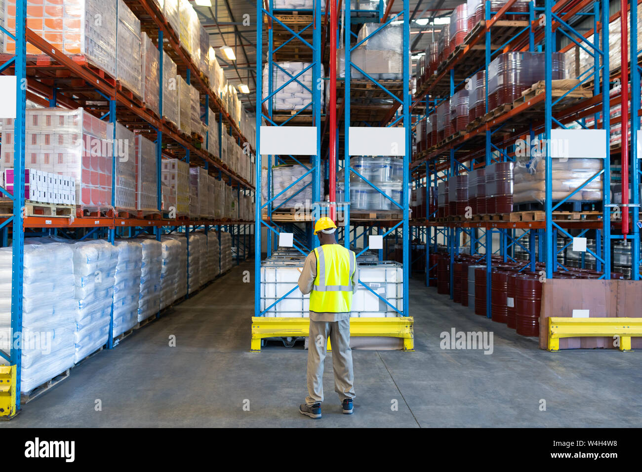 Male worker working in warehouse Stock Photo - Alamy