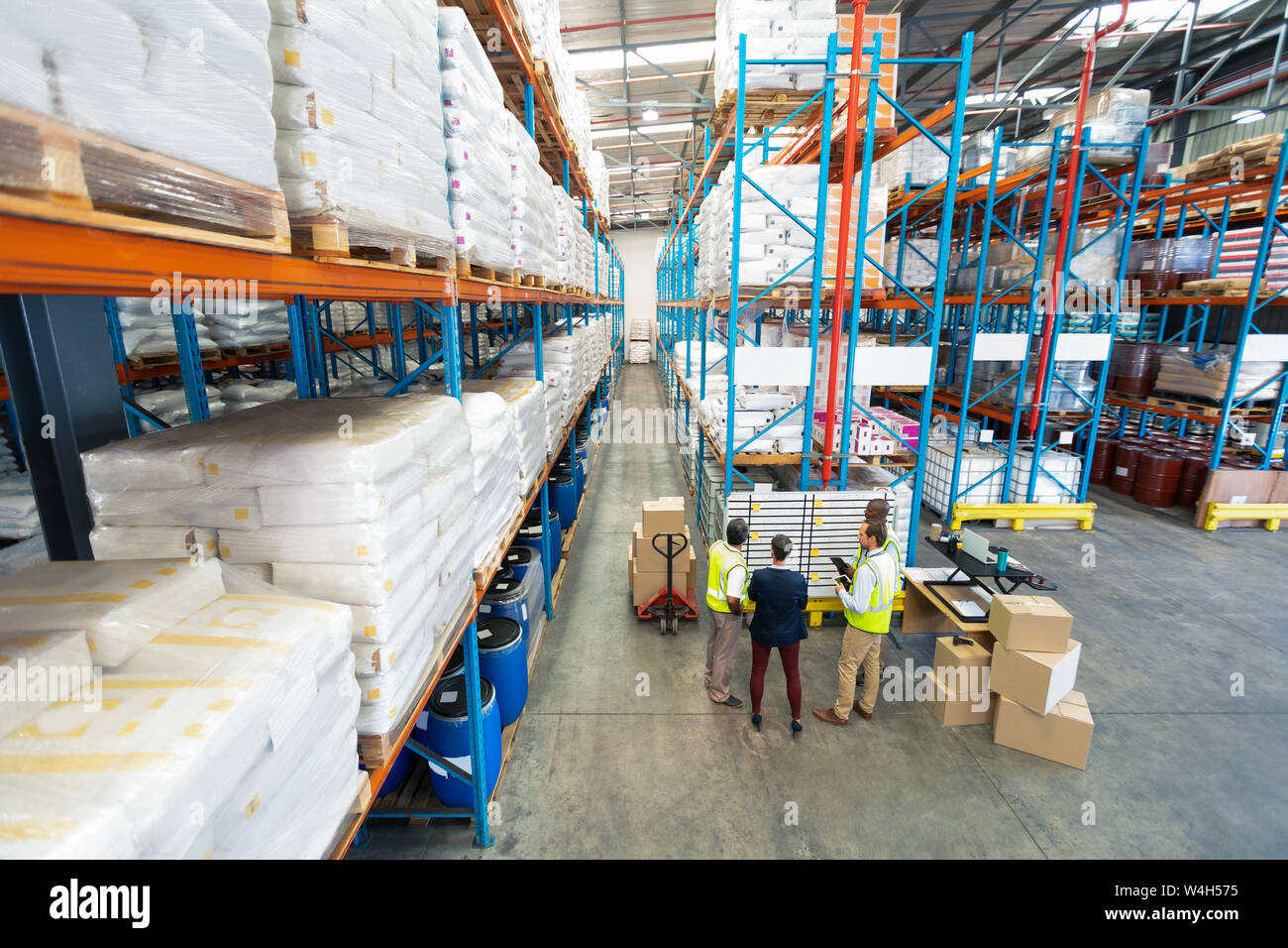 Warehouse staff discussing over whiteboard in warehouse Stock Photo - Alamy