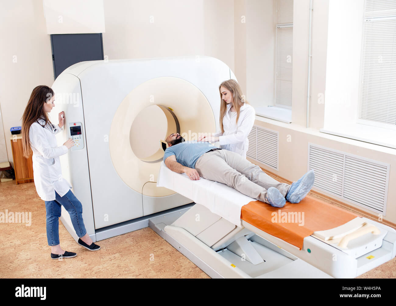 Happy patient undergoing mri scan at hospital Stock Photo - Alamy