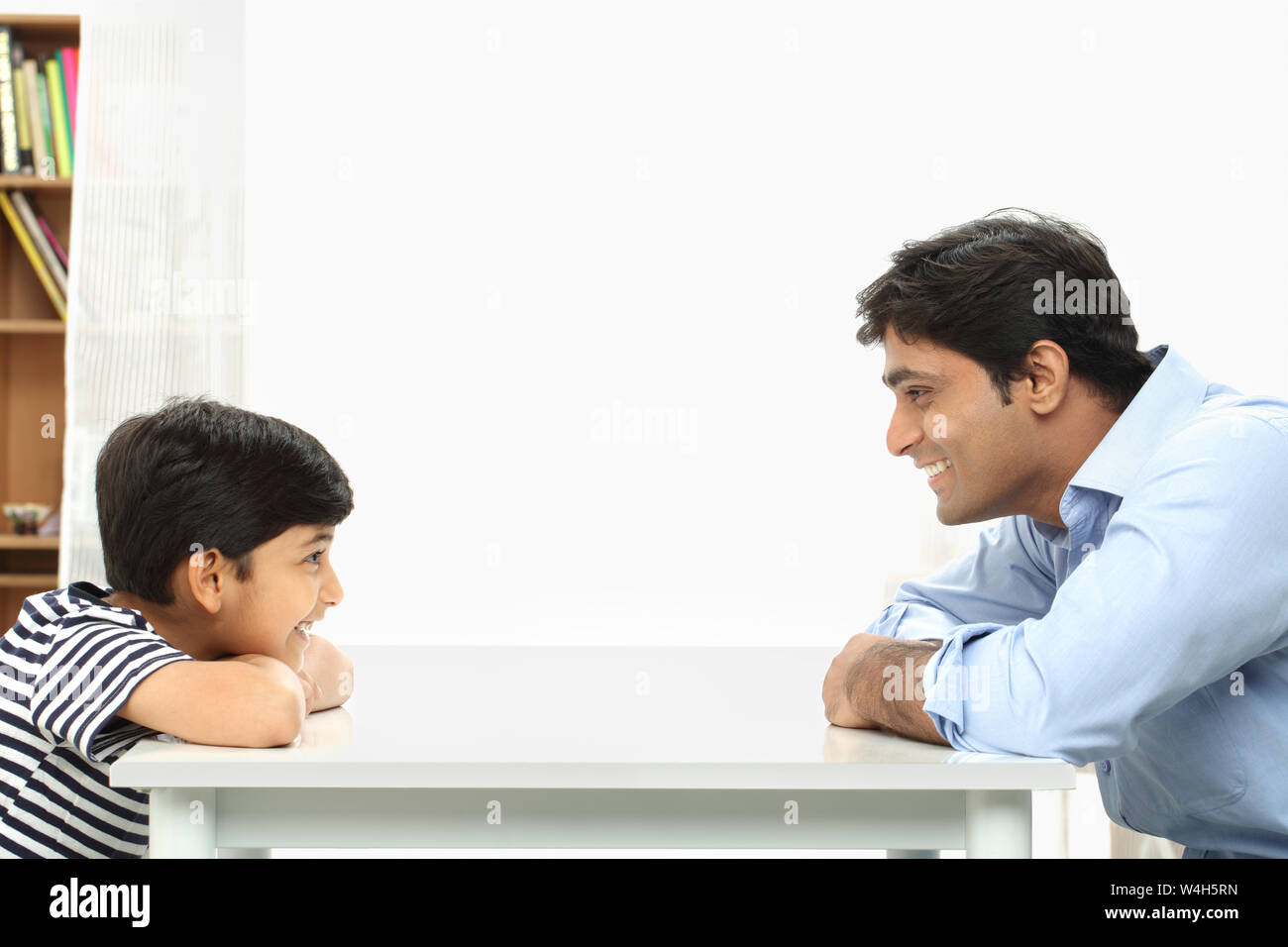 Father and son playing eye contact game and smiling Stock Photo - Alamy