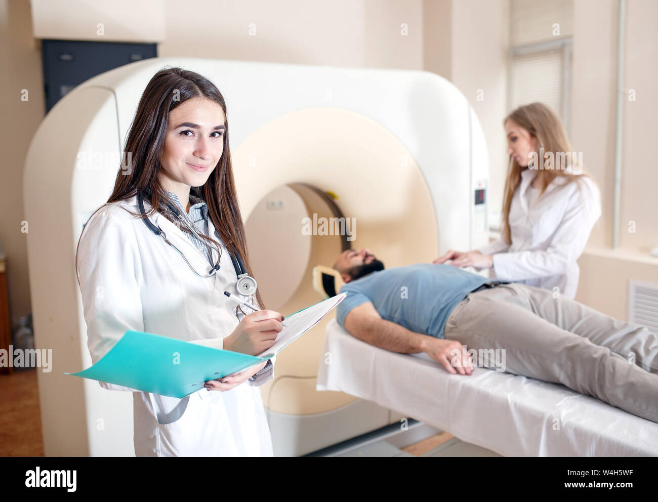 Happy patient undergoing mri scan at hospital Stock Photo - Alamy