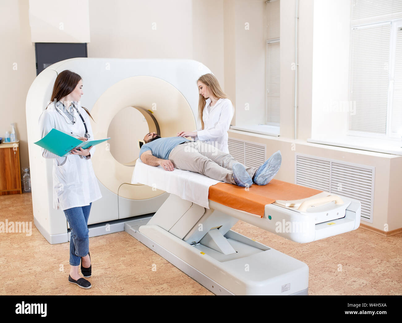 Happy patient undergoing mri scan at hospital Stock Photo - Alamy