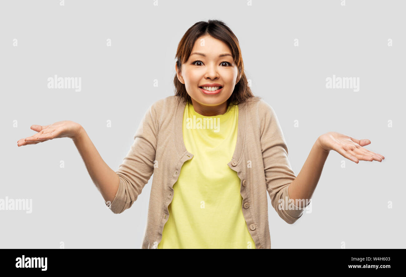 clueless asian woman shrugging Stock Photo - Alamy