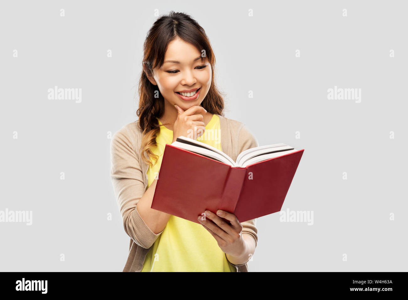 happy asian woman reading book Stock Photo - Alamy