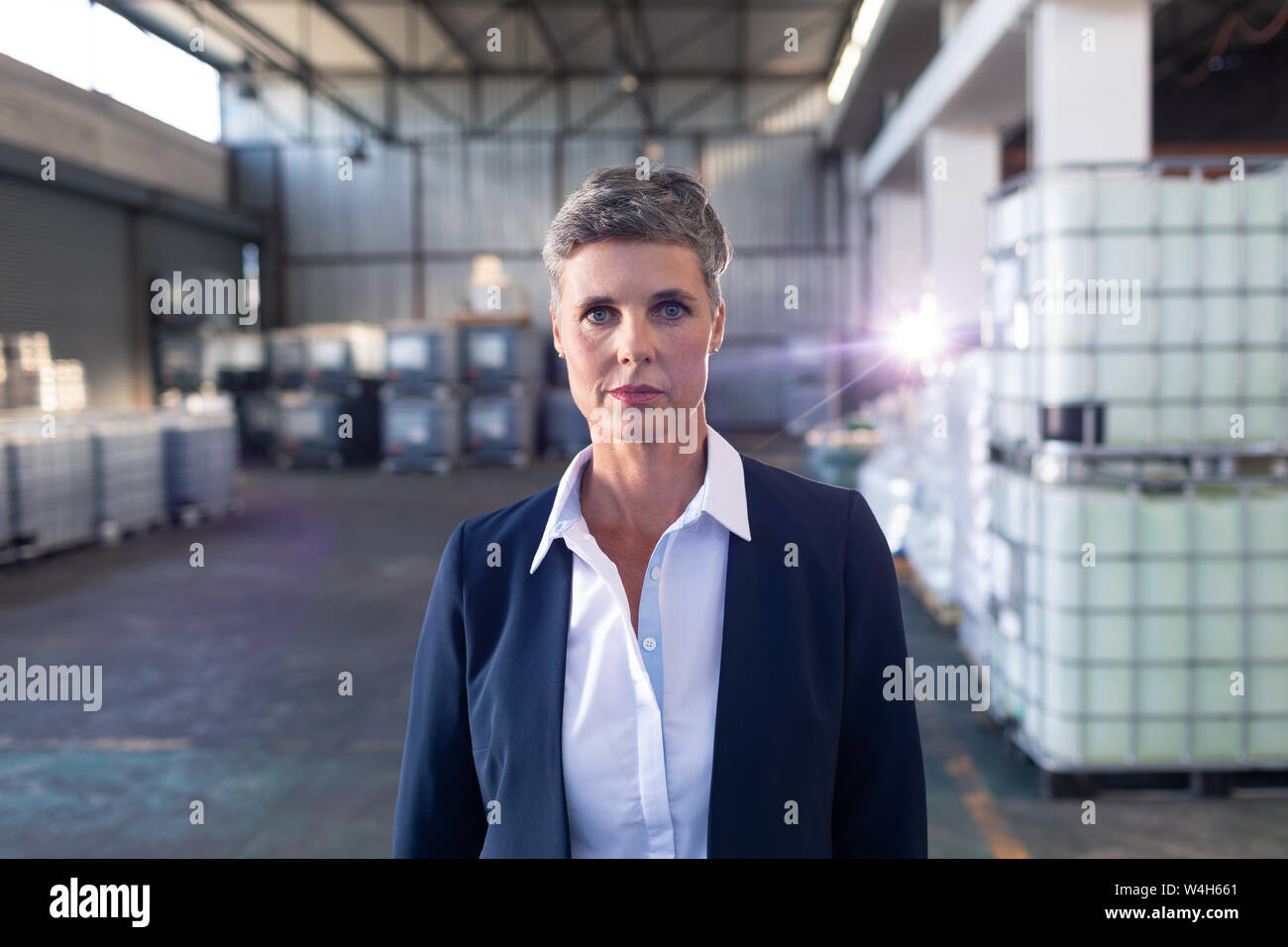 Mature female manager standing in warehouse Stock Photo - Alamy