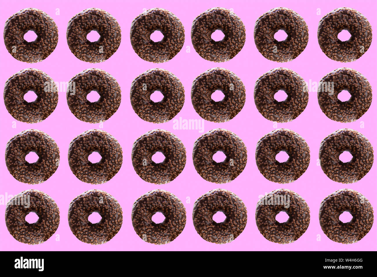 Chocolate donuts on a pink background. Cheerful, festive background and ...