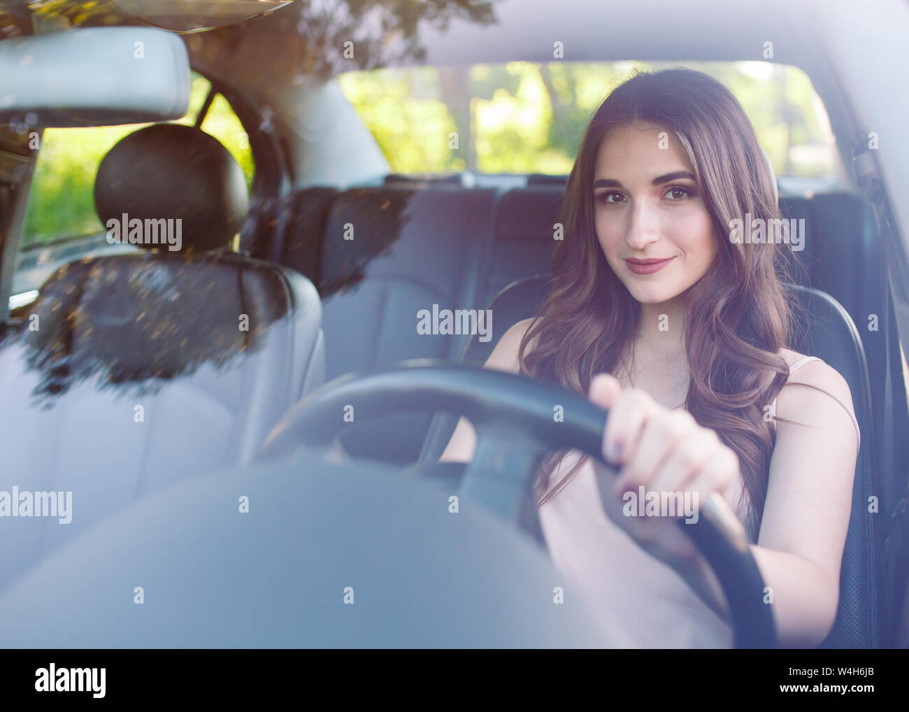 A young pretty girl is driving a car Stock Photo - Alamy