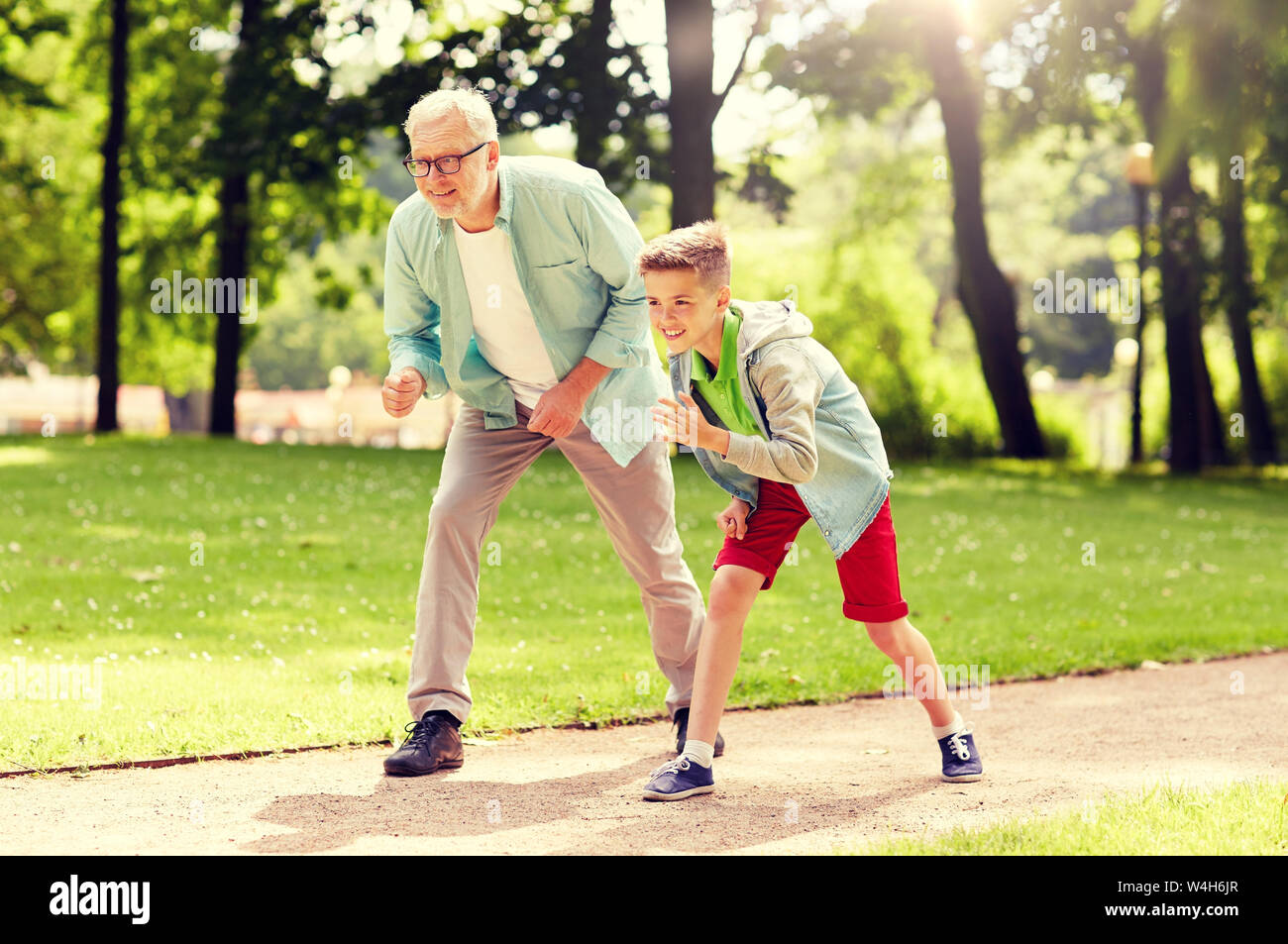 grandfather and grandson racing at summer park Stock Photo - Alamy