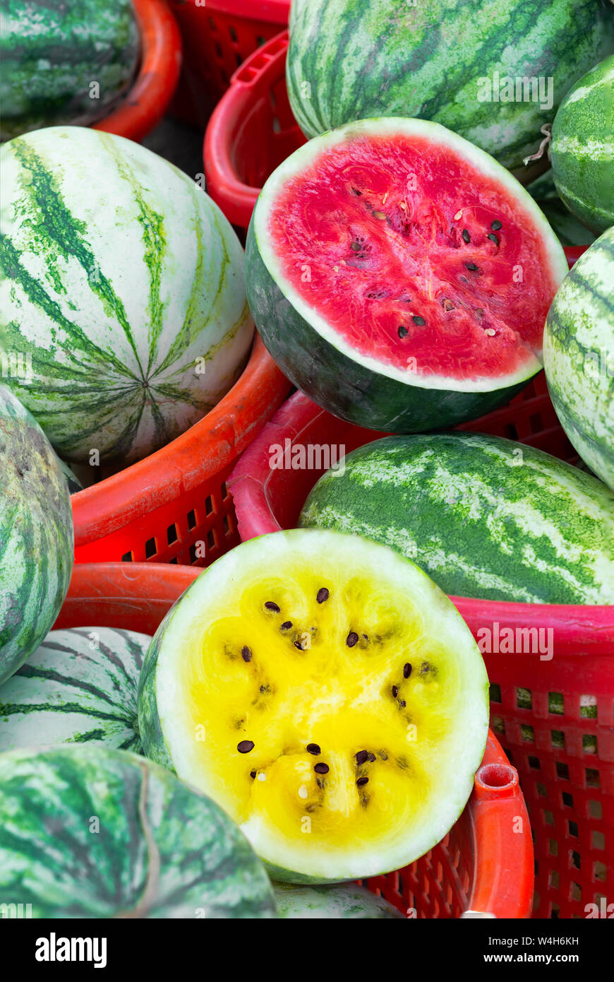 Yellow and red watermelon at a local farmer's market Stock Photo - Alamy